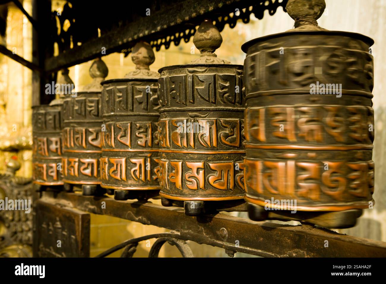 Bronze Tibetan prayer wheels or mani with the inscriptions in Sanskrit ...