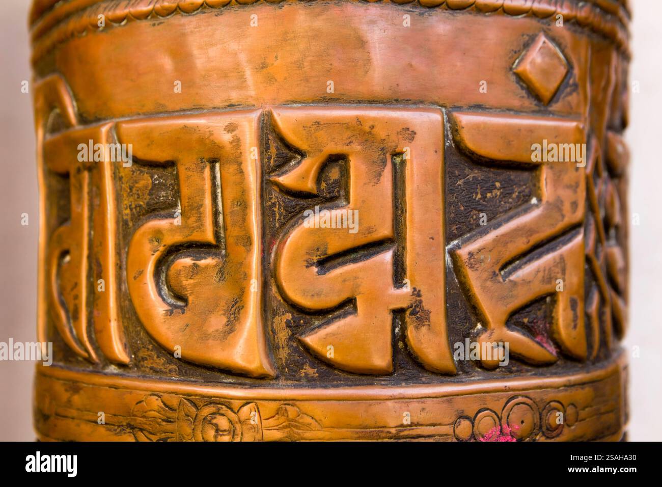 Bronze Tibetan prayer wheels or mani with the inscriptions in Sanskrit ...