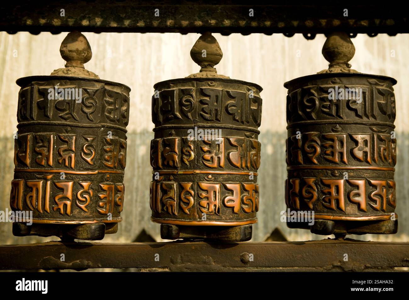 Bronze Tibetan prayer wheels or mani with the inscriptions in Sanskrit ...