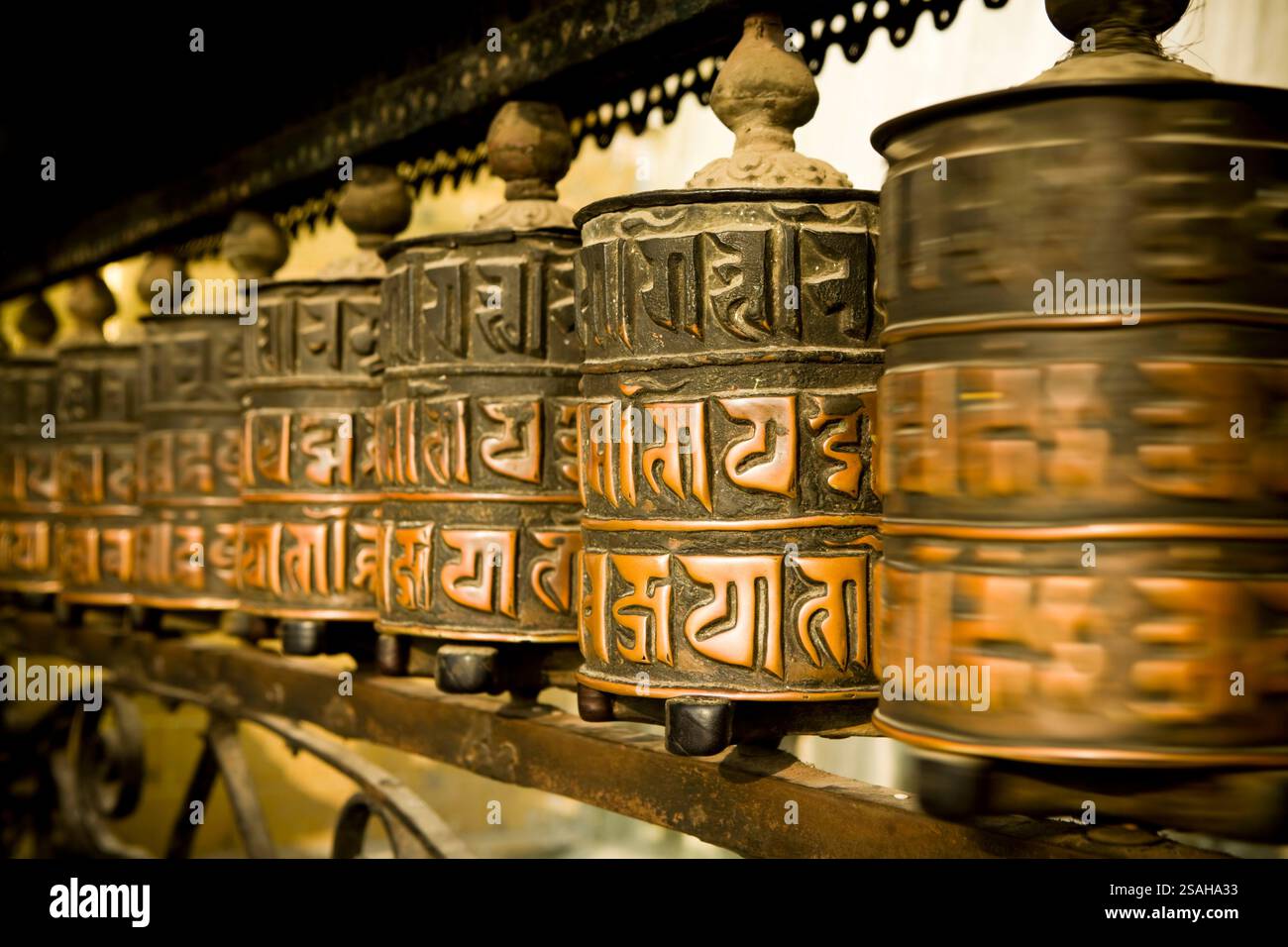 Bronze Tibetan prayer wheels or mani with the inscriptions in Sanskrit ...