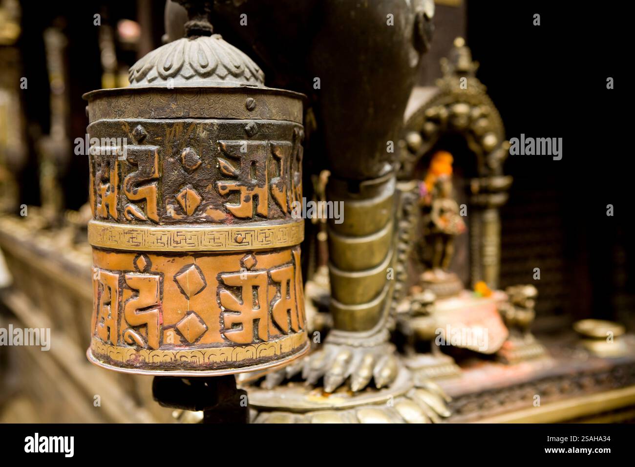 Bronze Tibetan prayer wheels or mani with the inscriptions in Sanskrit ...
