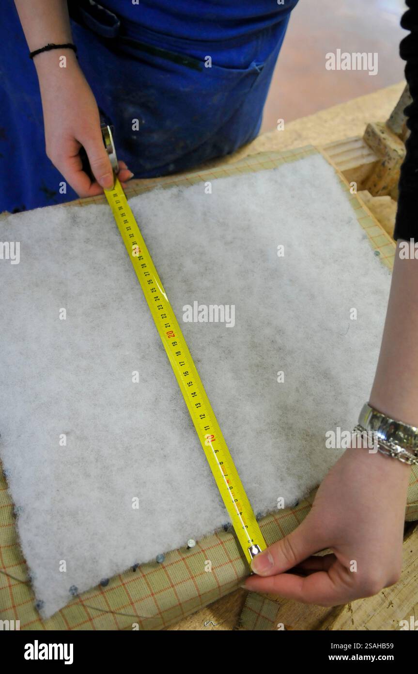 Measuring fabric with a tape measure for the restoration of an old ...