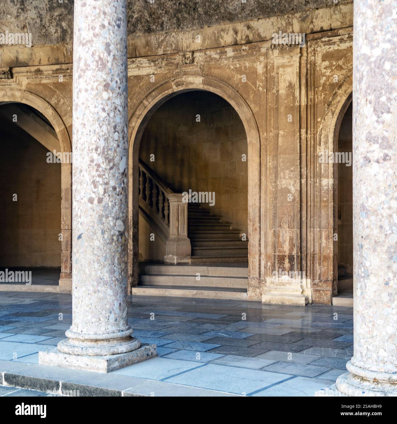 A serene architectural interior featuring stone columns and arched ...