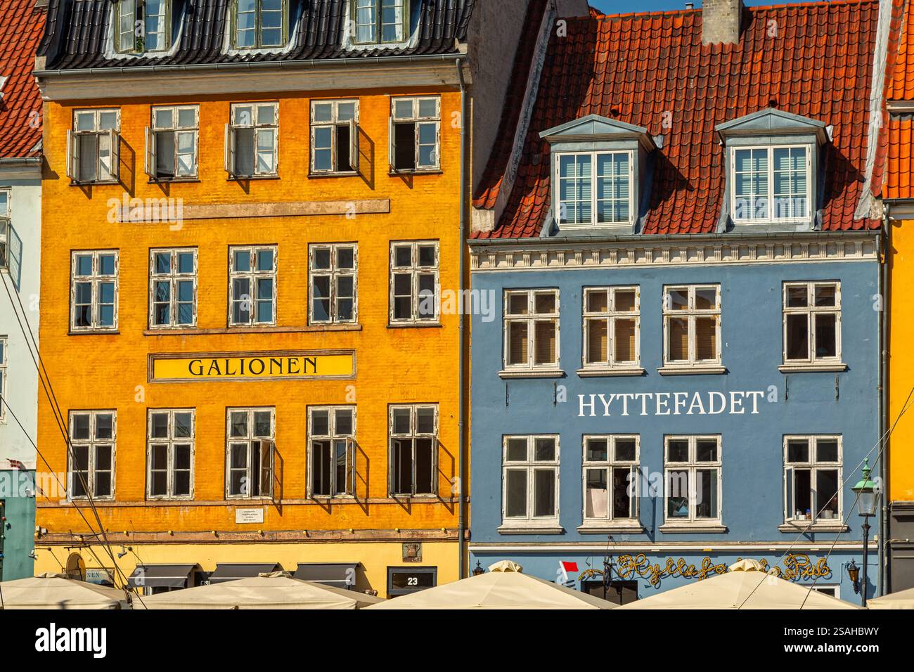 The northern side of Nyhavn, Copenhagen's old harbour. is lined with ...