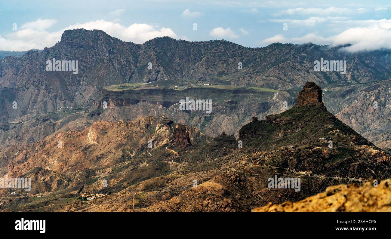 A panoramic view of rugged mountains with steep cliffs and rocky ...
