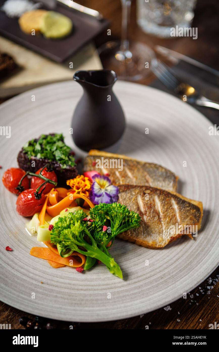 Pan-seared fish fillet with vibrant vegetables, including broccoli ...