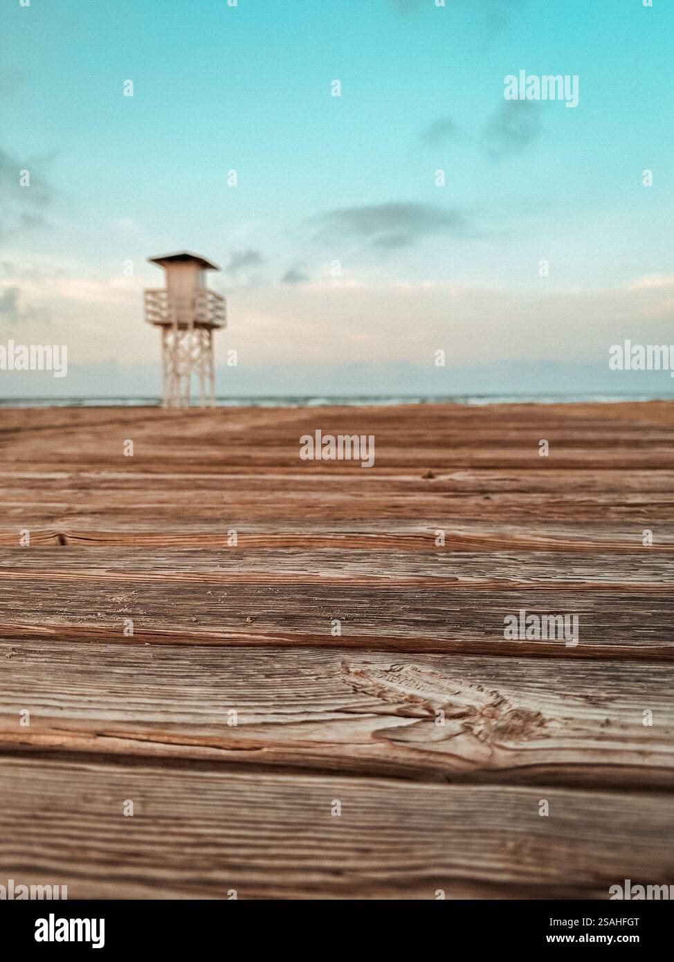 A white wooden lifeguard watchtower located on the beach. A rescue ...