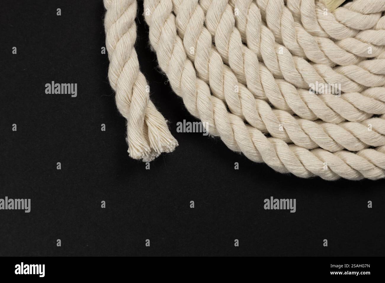 Coiled rope over a dark background Stock Photo - Alamy