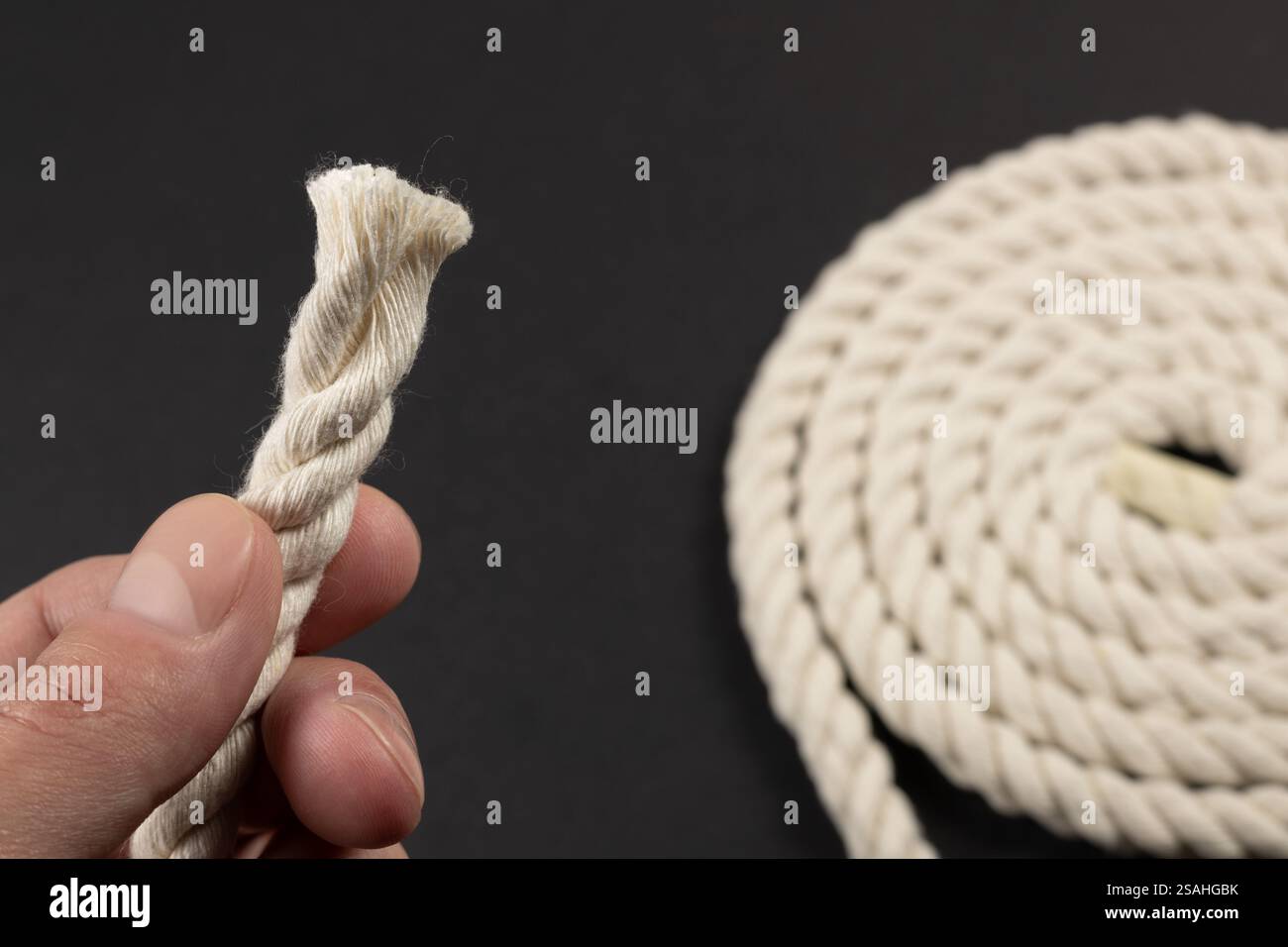 Hand holding rope hi-res stock photography and images - Alamy