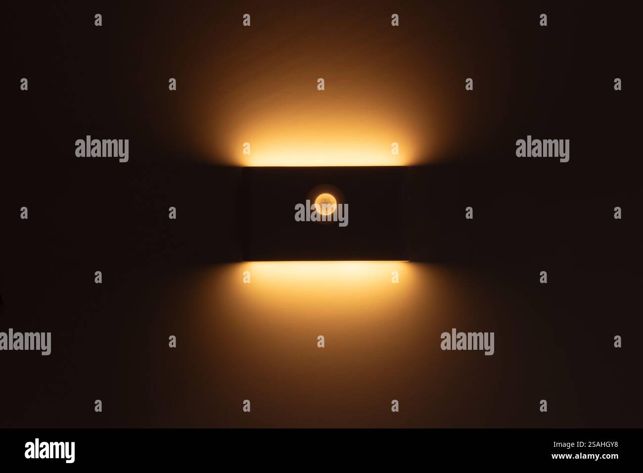 The lamp shines with warm light on the wall. Warm lighting Stock Photo ...