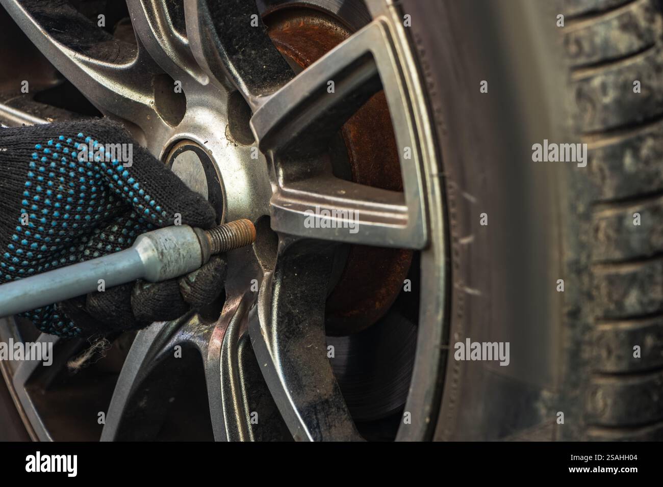 Removing car mechanic to repair the leaky tire car wheels. Mechanic ...