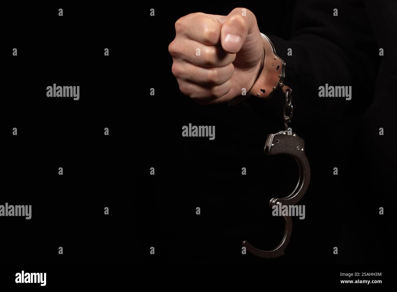 Picture of handcuffs,hanging on stretched hand Stock Photo - Alamy