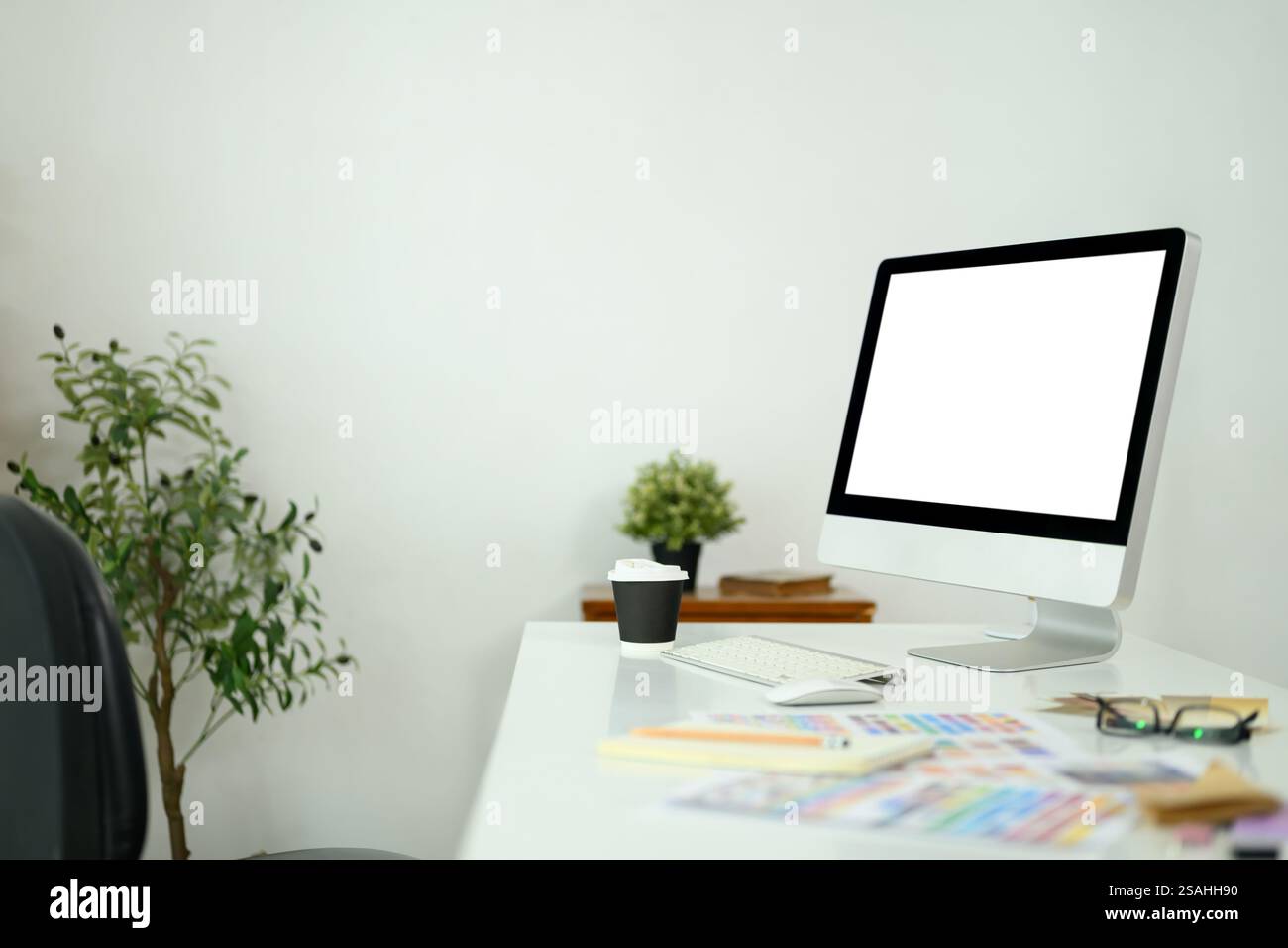 Creative workspace with computer monitor, color palettes, and design ...