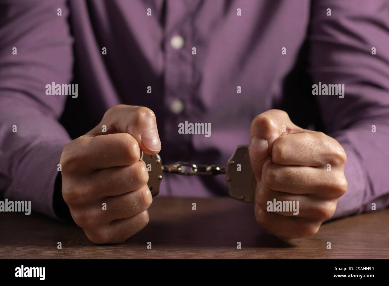 Man on the chair in Handcuffs. Men criminal in handcuffs arrested for ...
