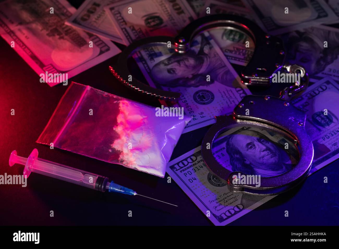 Drug smuggling and trafficking and handcuffs side gun money and bags of ...