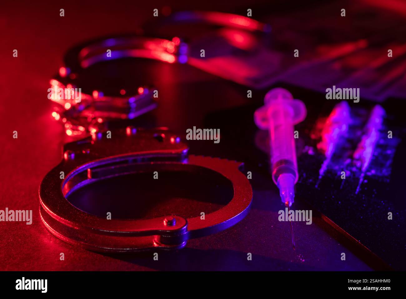 Drug smuggling and trafficking and handcuffs side gun money and bags of ...