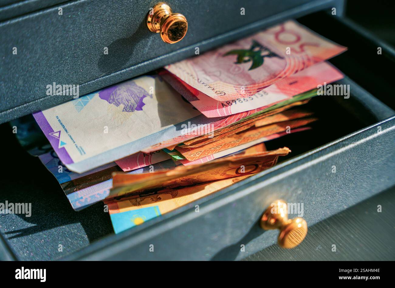Tenge banknotes of different denominations are lying in a casket ...