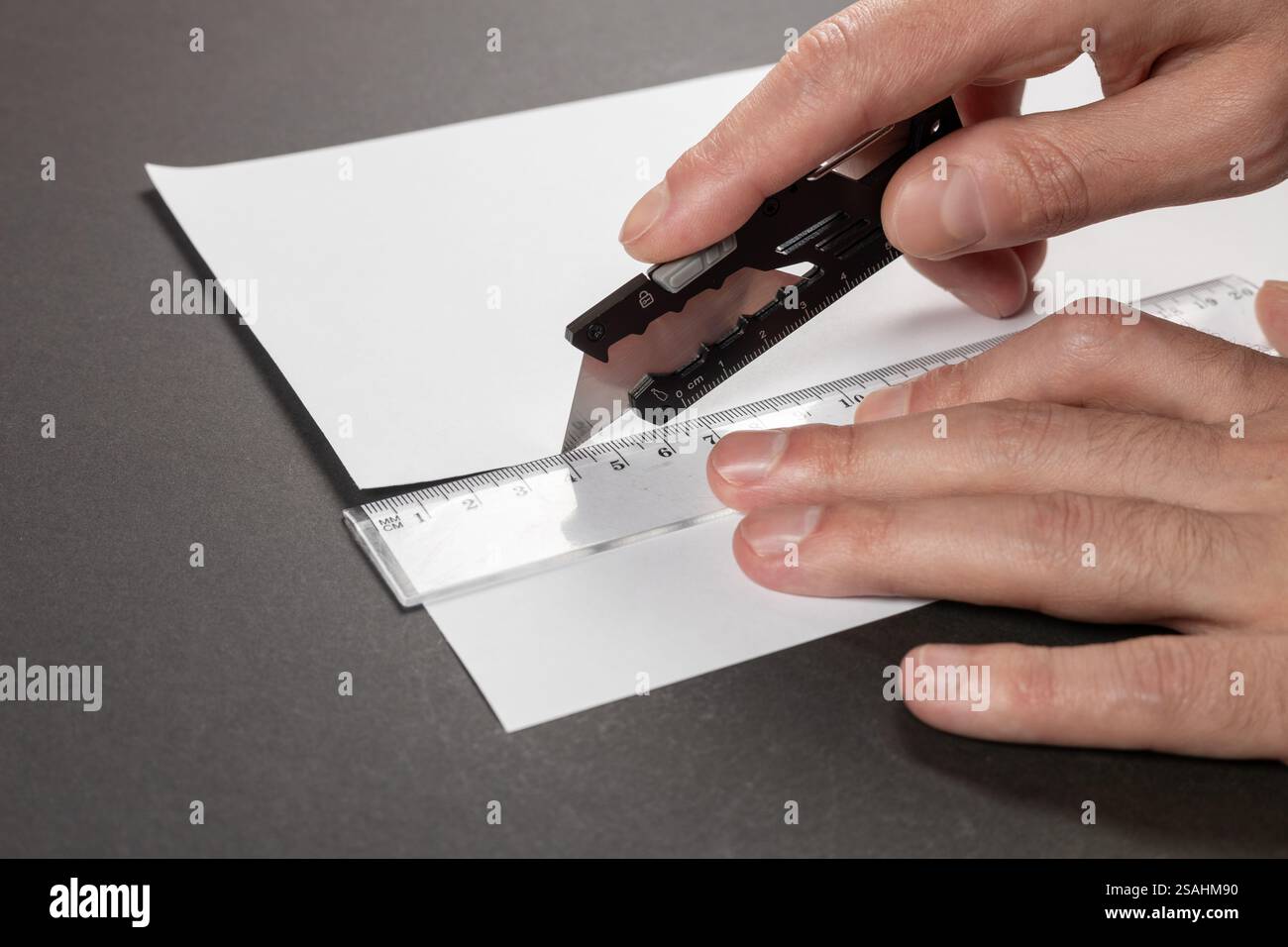 Man cuts paper stationery hi-res stock photography and images - Alamy