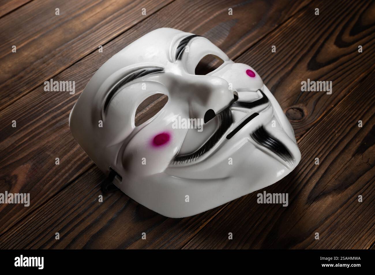 Dnipro. Ukraine 30 jan 2024: Vendetta mask on wooden background. This ...