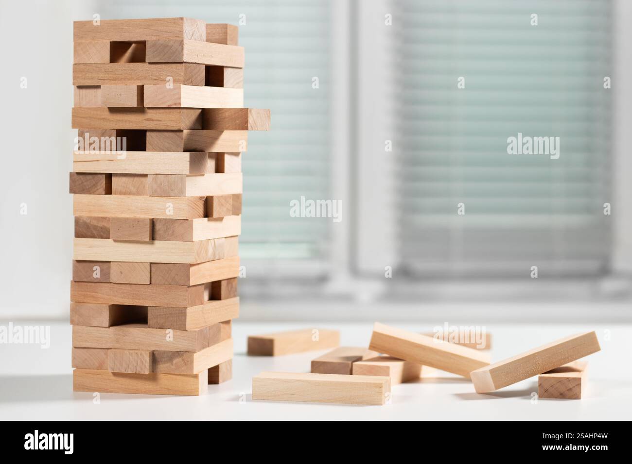 Board game Tower made of wooden blocks. A tower of unevenly shifted ...