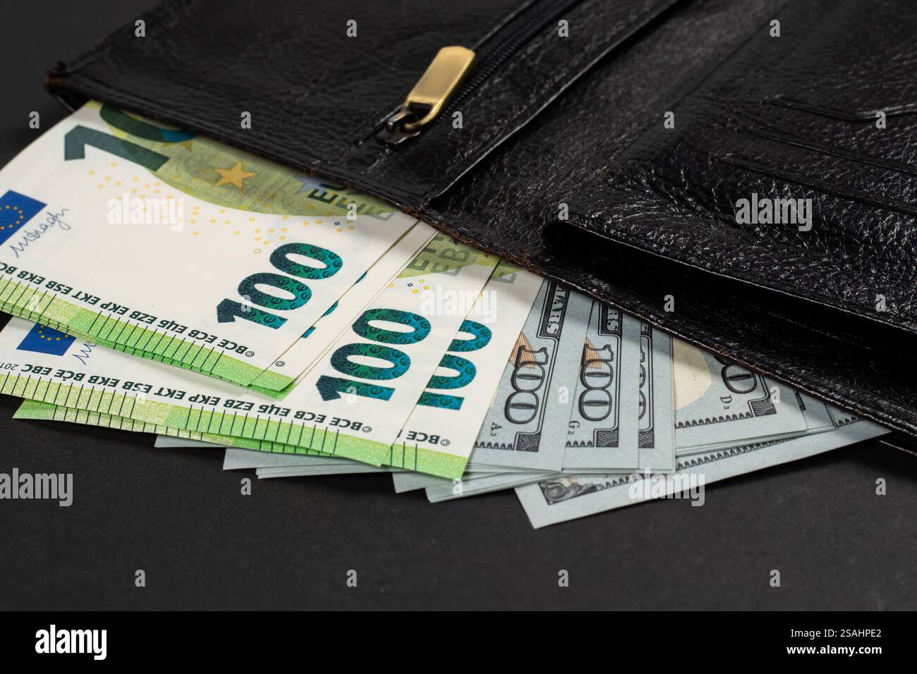 Cash of 100 dollar and 100 euro note, in wallet. Lot of one hundred ...