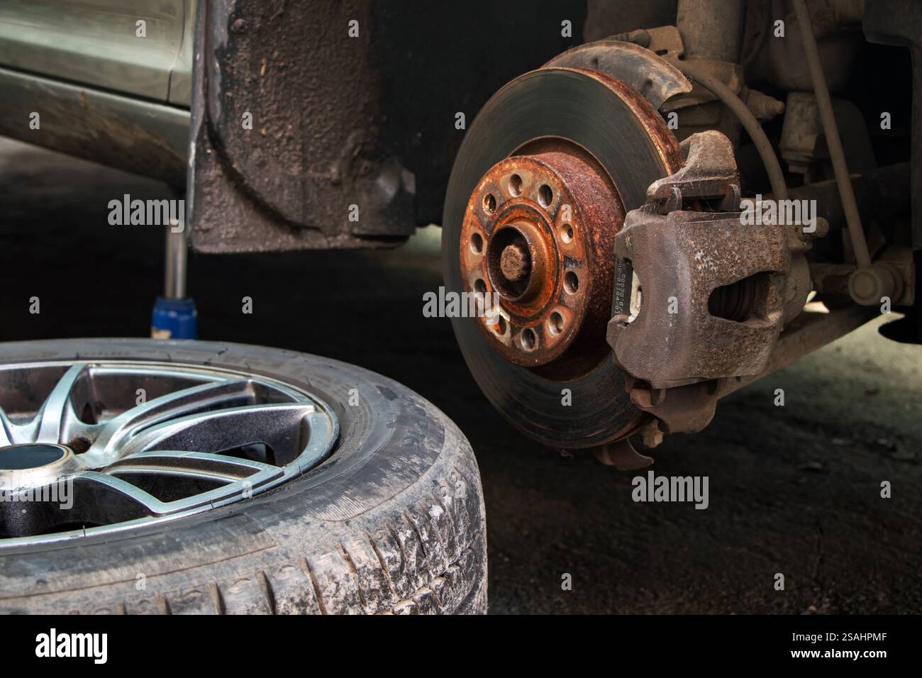 Closeup disc brake of the vehicle for repair. shot wheel, the tool for ...