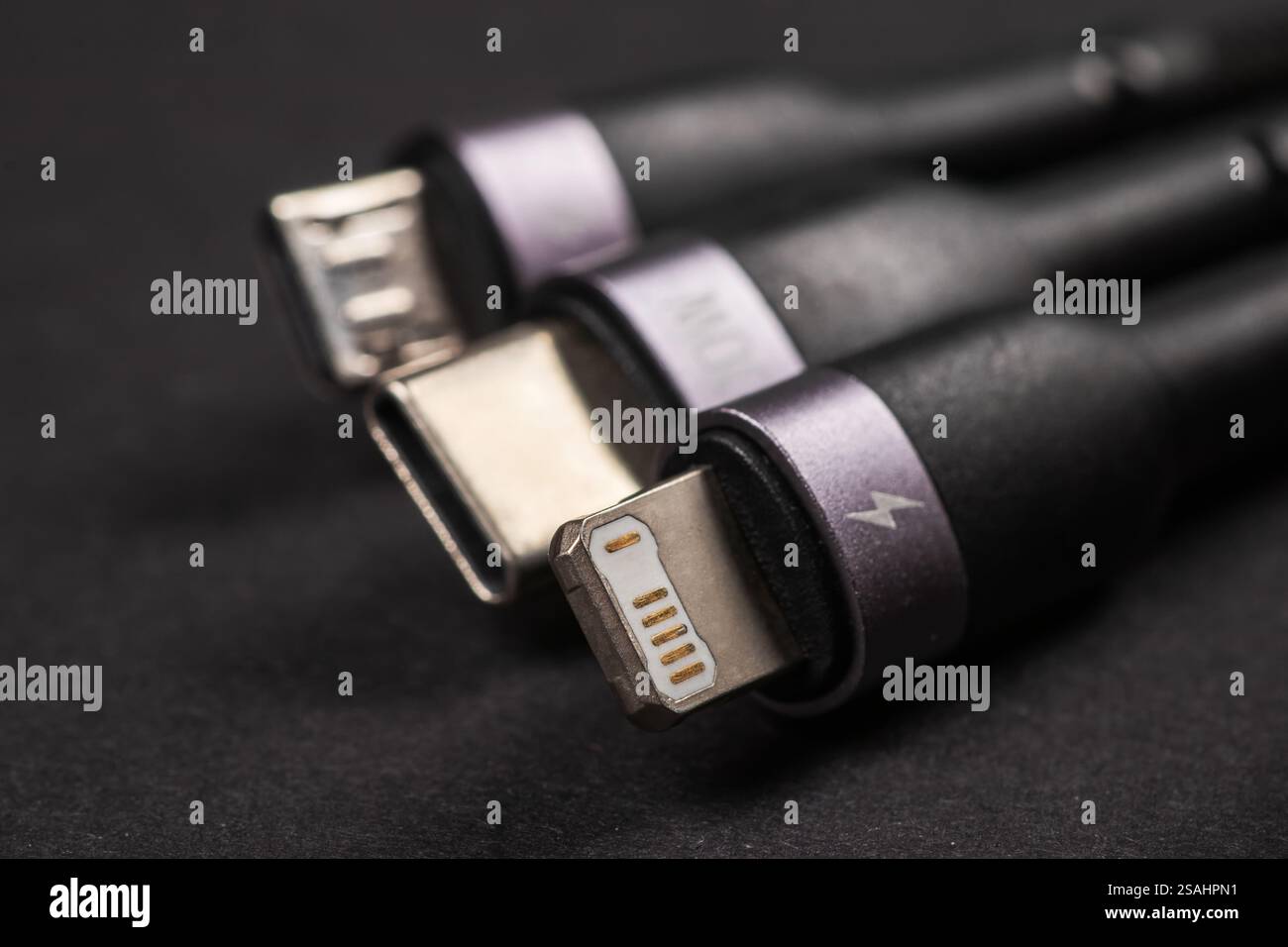 Different USB charging plugs on dark background. USB Type C, Micro USB ...