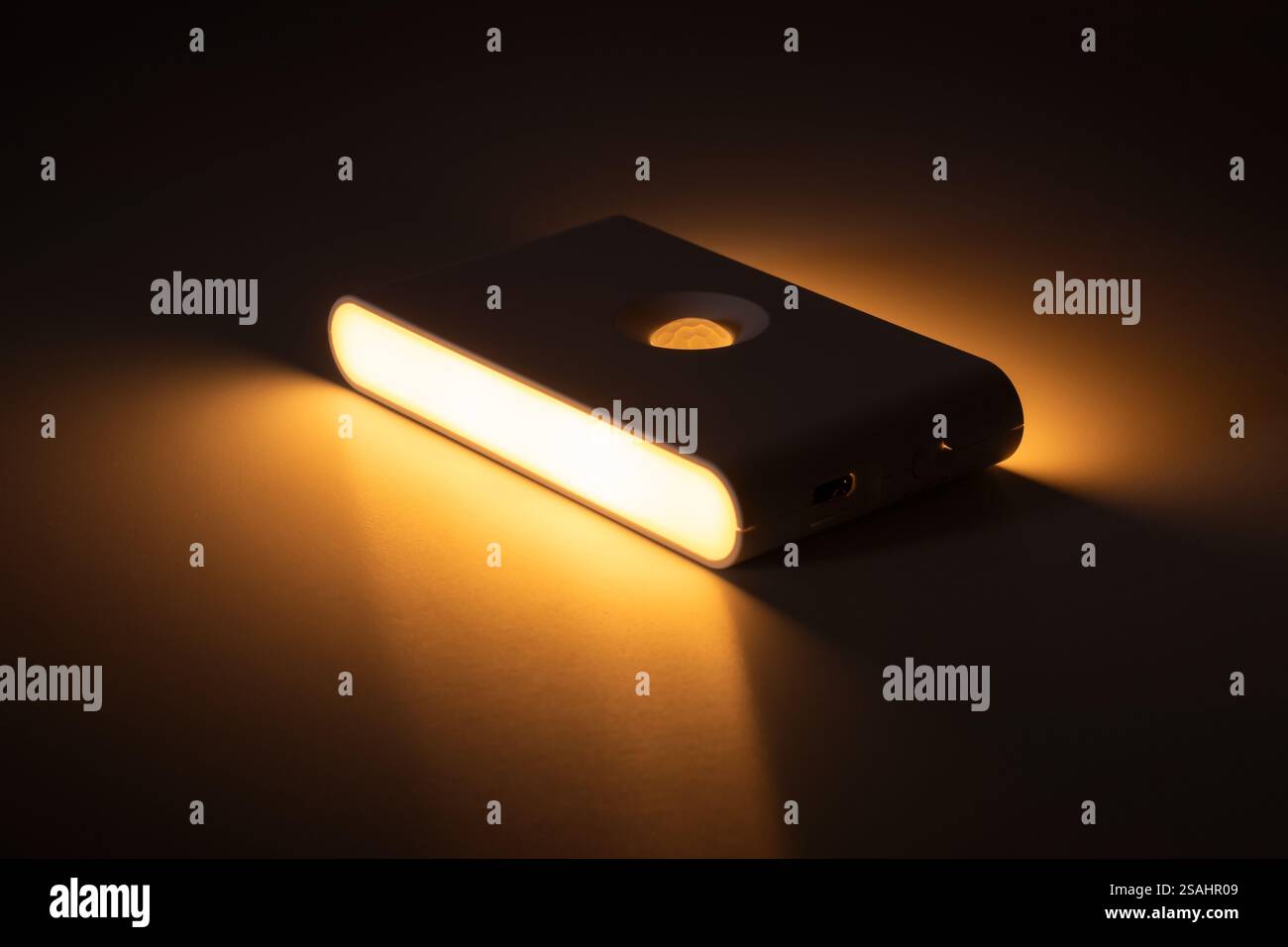The lamp shines with warm light on the wall. Warm lighting Stock Photo ...