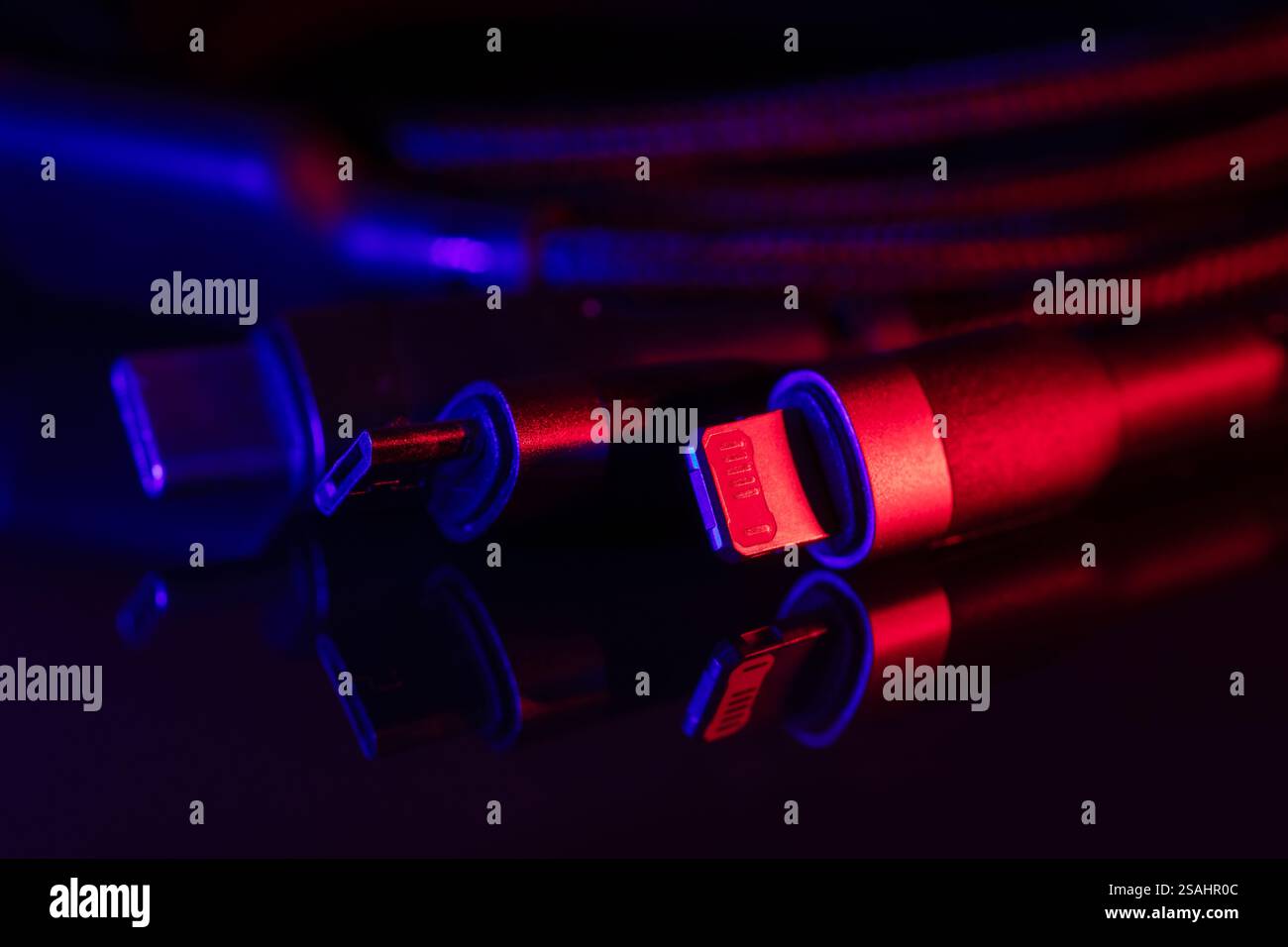 Different USB charging plugs on dark background. USB Type C, Micro USB ...