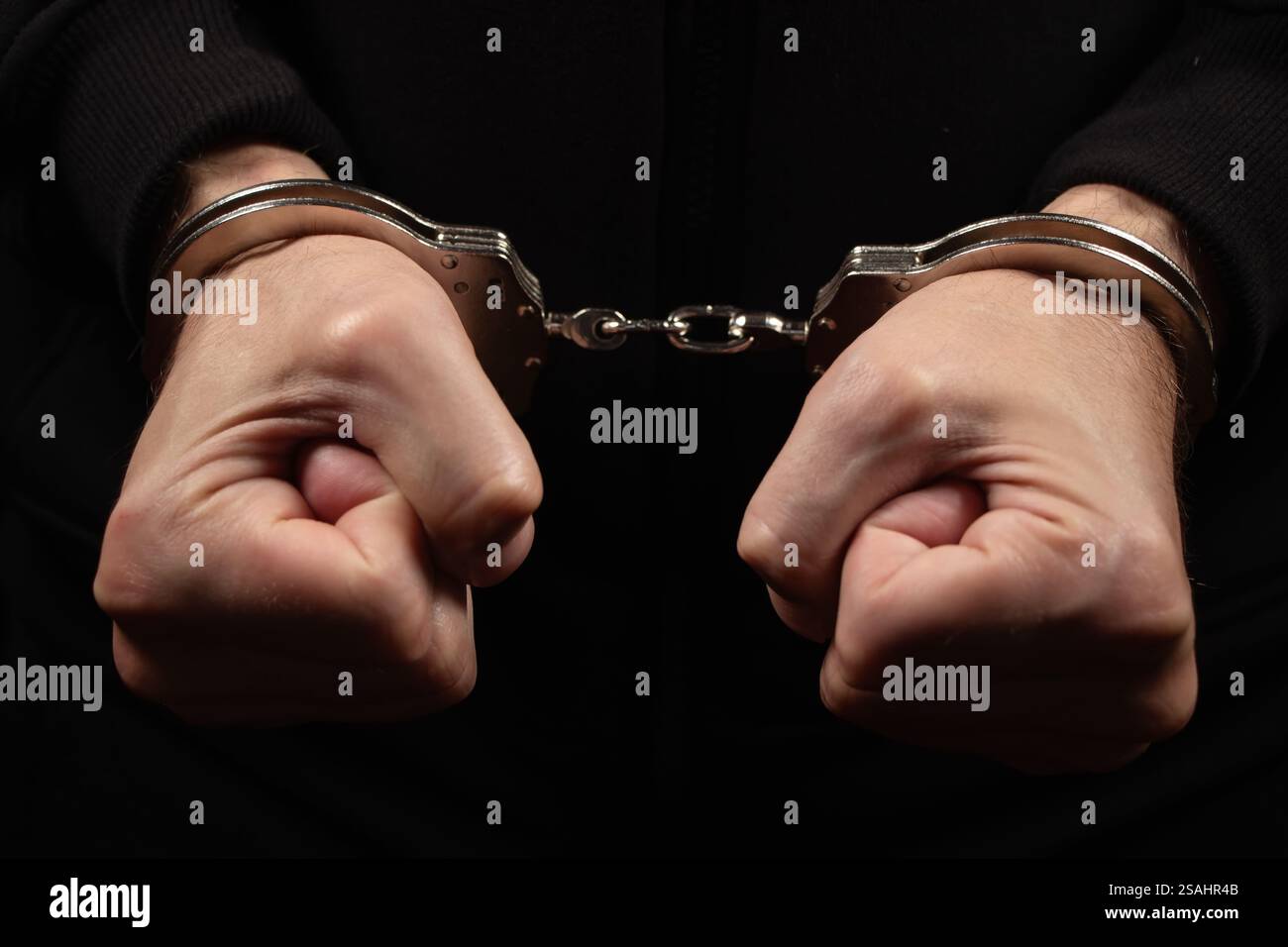 Woman hands in handcuffs behind back hi-res stock photography and ...