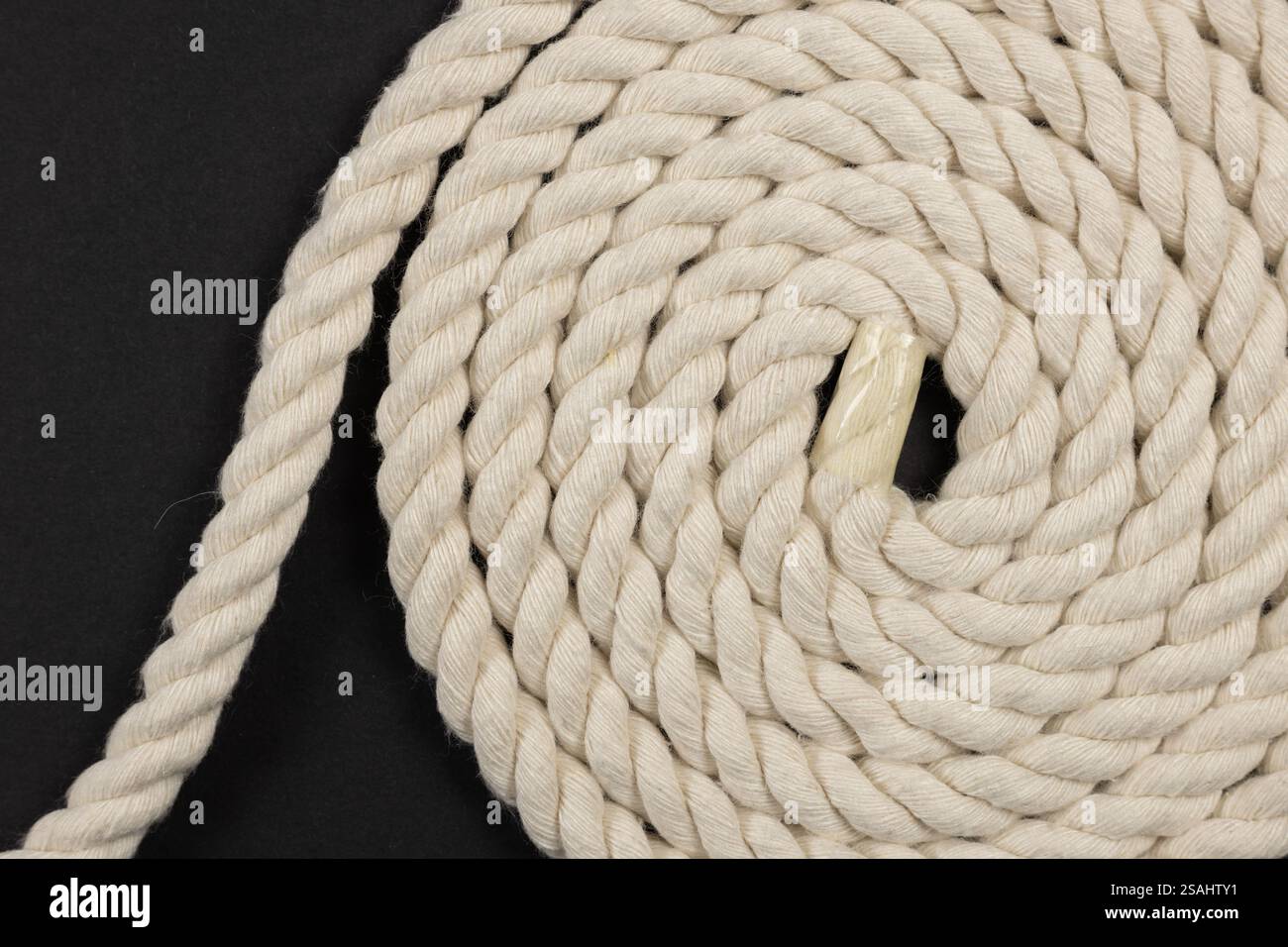 Coiled rope over a dark background Stock Photo - Alamy