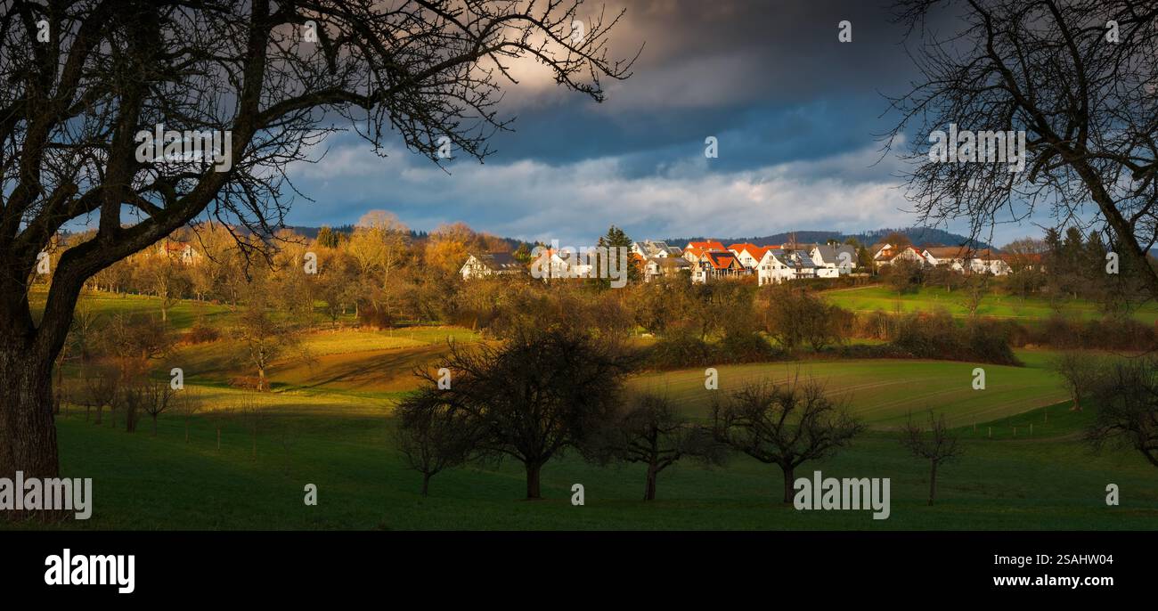Small village on a scenic hill in panoramic rural landscape with ...