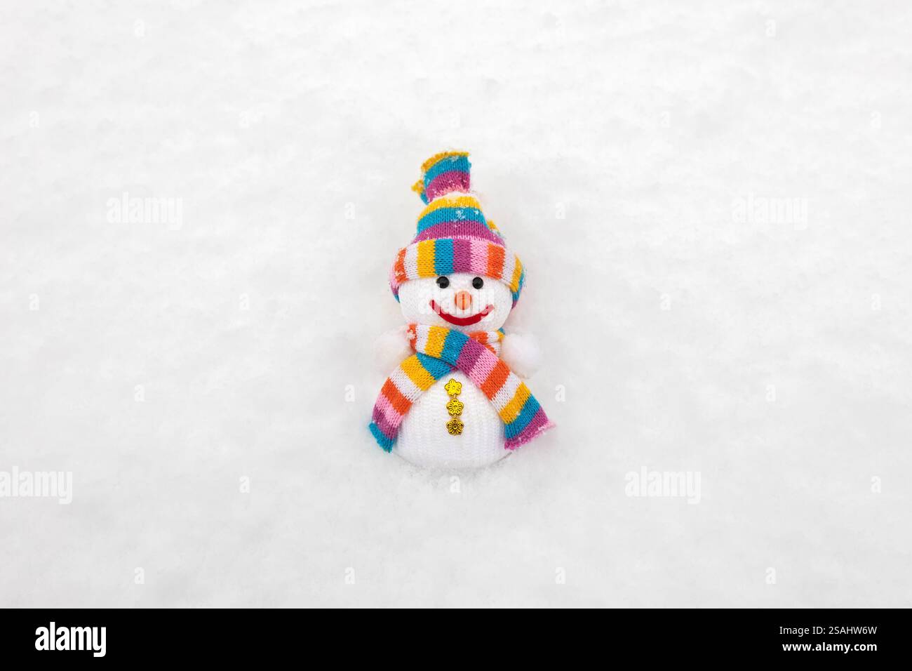 A fabric snowman in a scarf and hat on the snow in winter Stock Photo ...