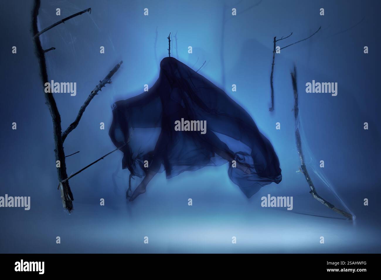 Faceless ballerina in black veil dancing in foggy surroundings ...