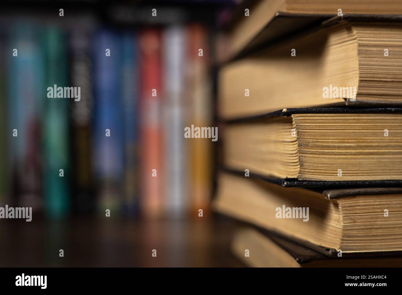 Book stack in the library room and blurred bookshelf for business and ...
