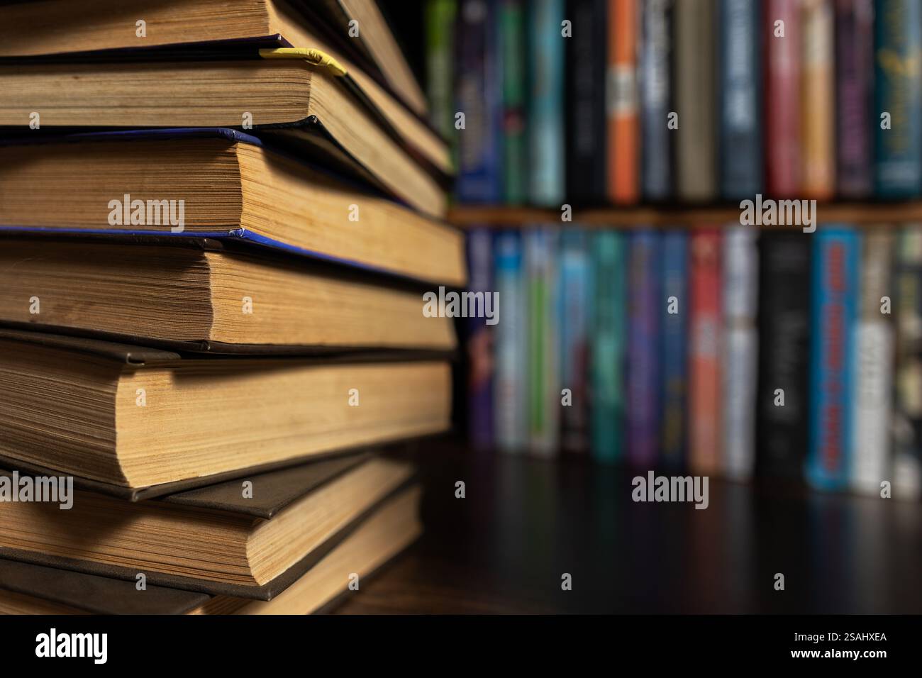Book stack in the library room and blurred bookshelf for business and ...