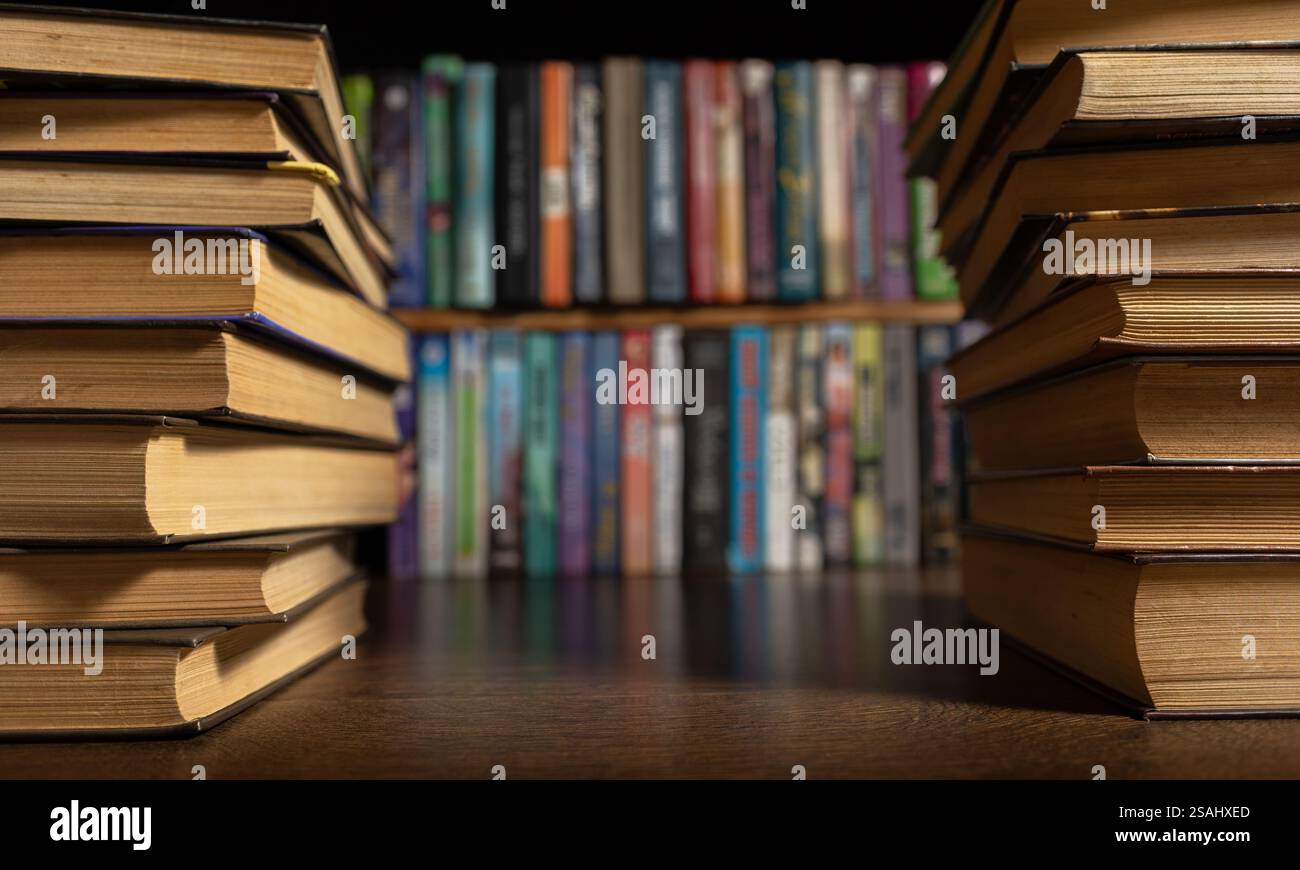 Book stack in the library room and blurred bookshelf for business and ...