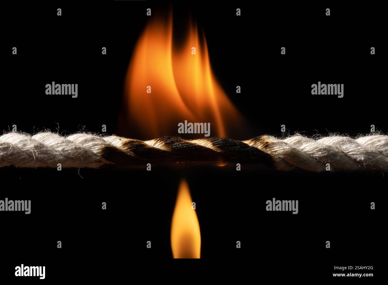 Burning rope at breaking point on black background, Risk concept Stock ...