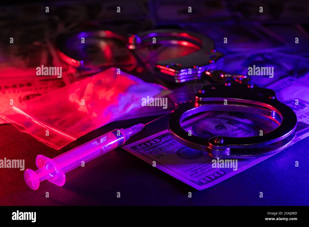 Drug smuggling and trafficking and handcuffs side gun money and bags of ...