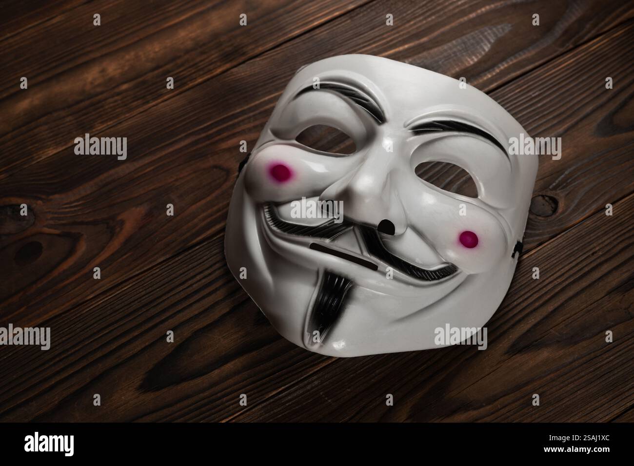 Dnipro. Ukraine 30 jan 2024: Vendetta mask on wooden background. This ...