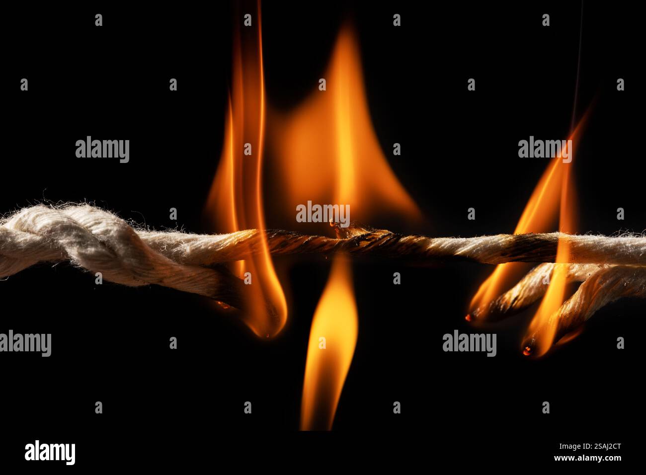 Burning rope at breaking point on black background, Risk concept Stock ...