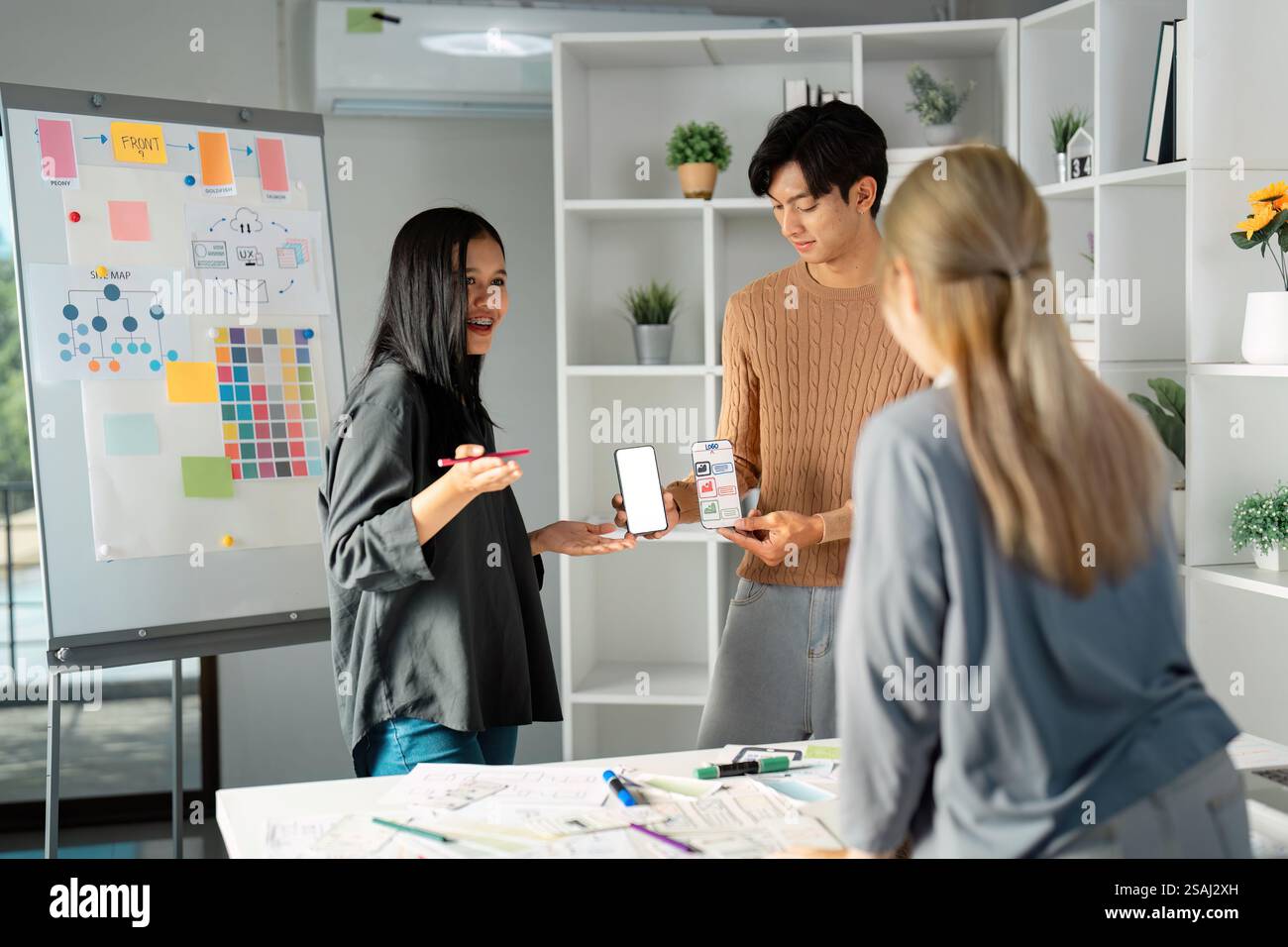 Team presenting UX UI designs with smartphone mockups and visuals Stock ...