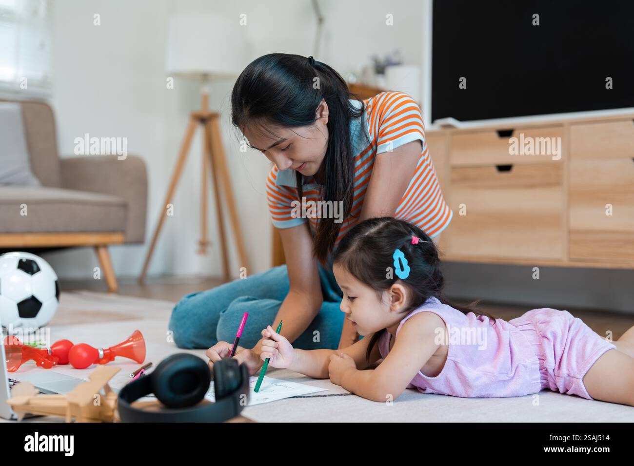 Mother and toddler engaged in creative drawing on the floor, nurturing ...