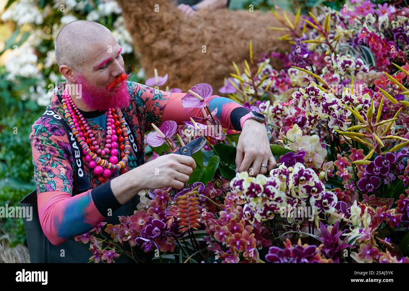 A horticulturist puts the finishing touches to a colourful display in ...