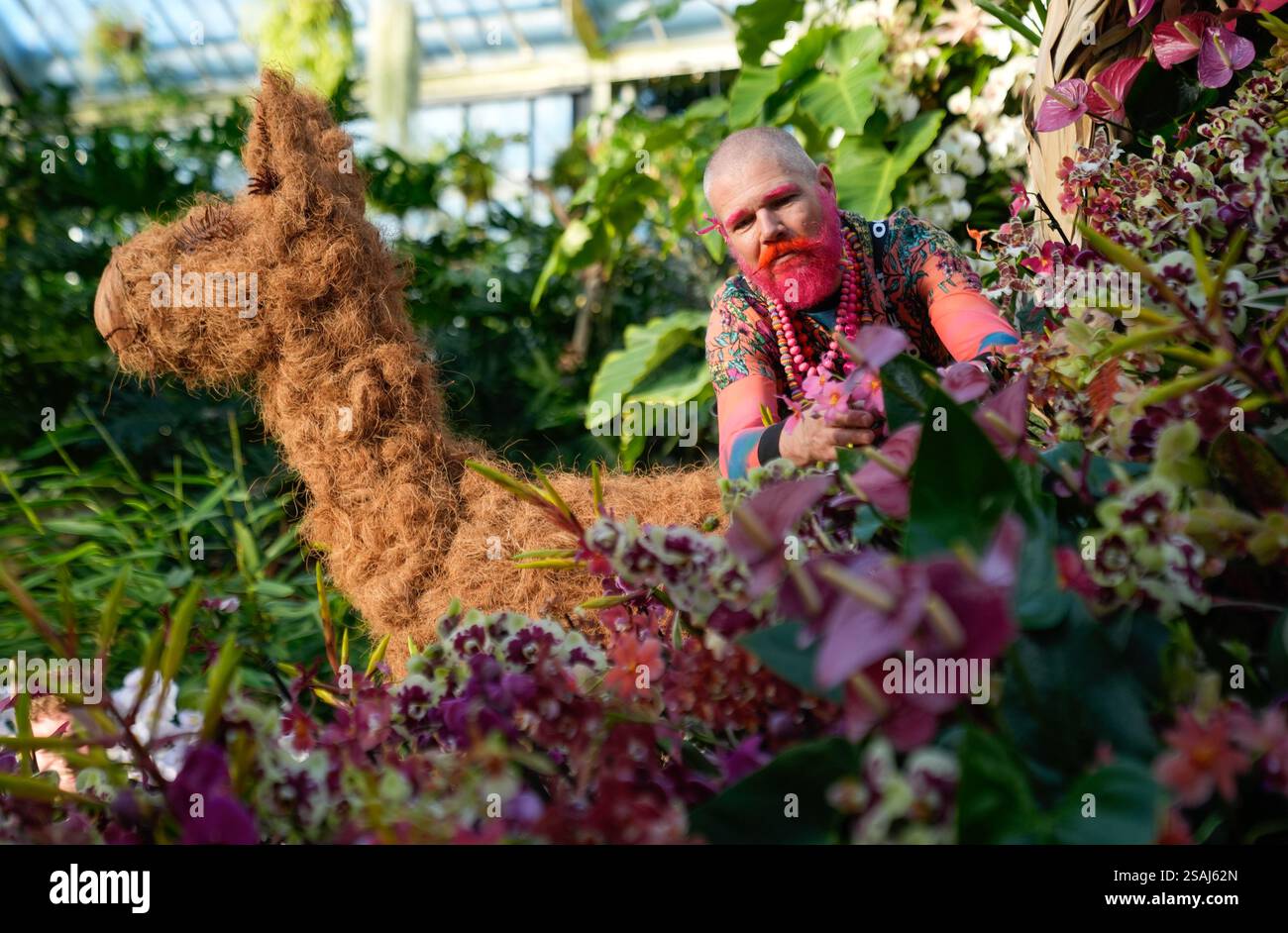 A horticulturist puts the finishing touches to a colourful display in ...