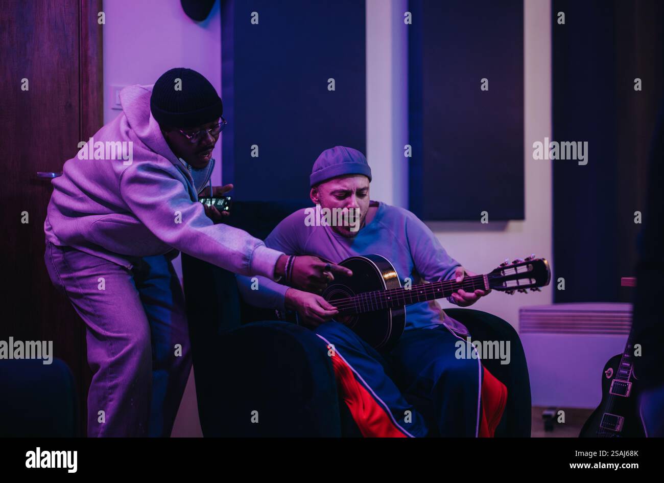 Multiracial musicians collaborating in a cozy music studio environment ...