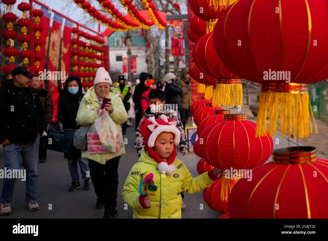 A girl walks past red lanterns during the Longtan Park Temple Fair on ...