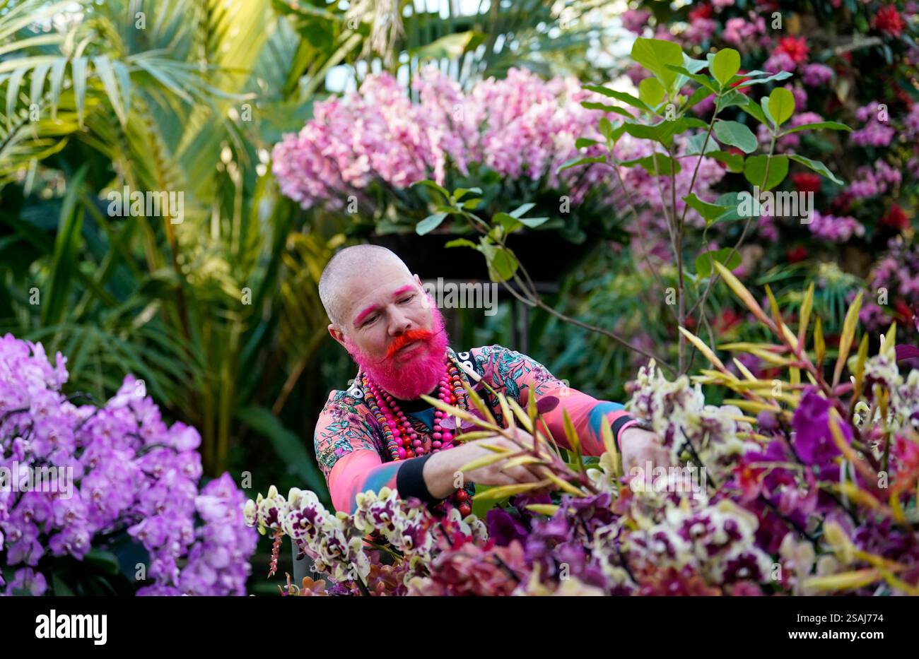 A horticulturist puts the finishing touches to a colourful display in ...
