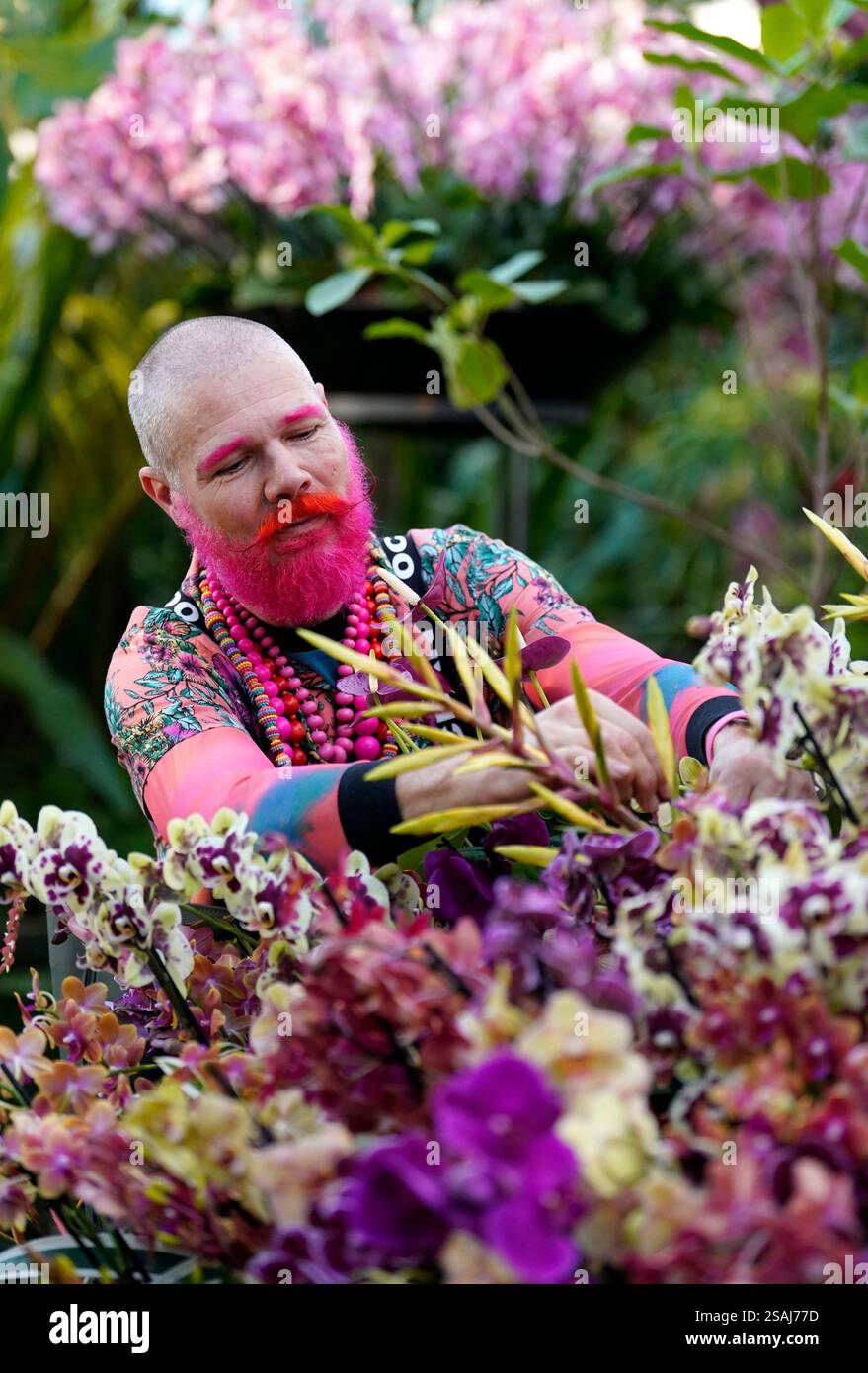 A horticulturist puts the finishing touches to a colourful display in ...
