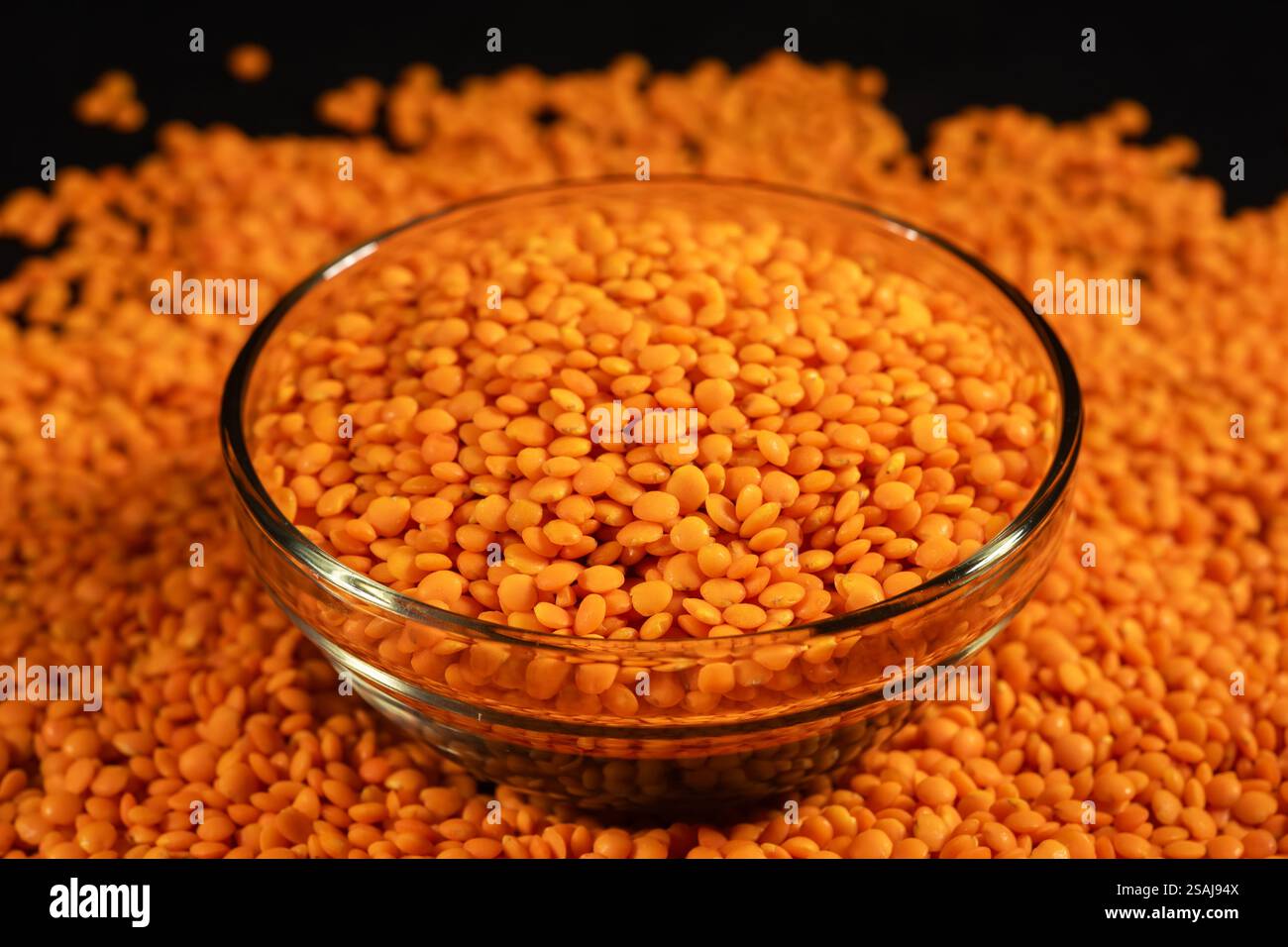 Red lentils in glass bowl. Dry orange lentil grains, heap of dal, raw ...